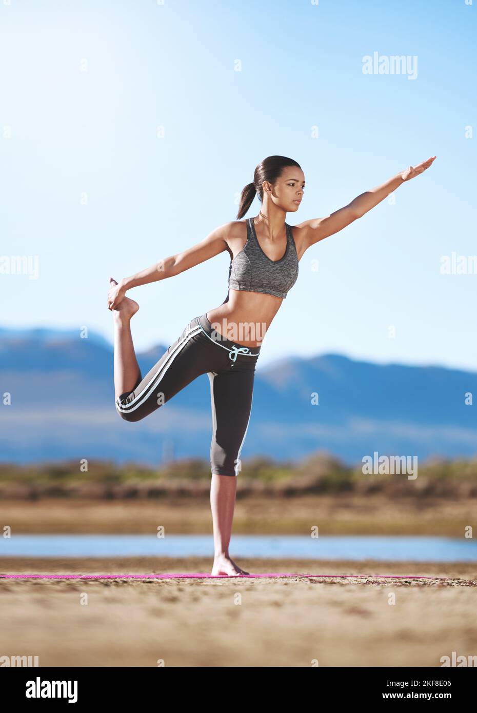 Life is all about balance. a young woman exercising outdoors Stock ...