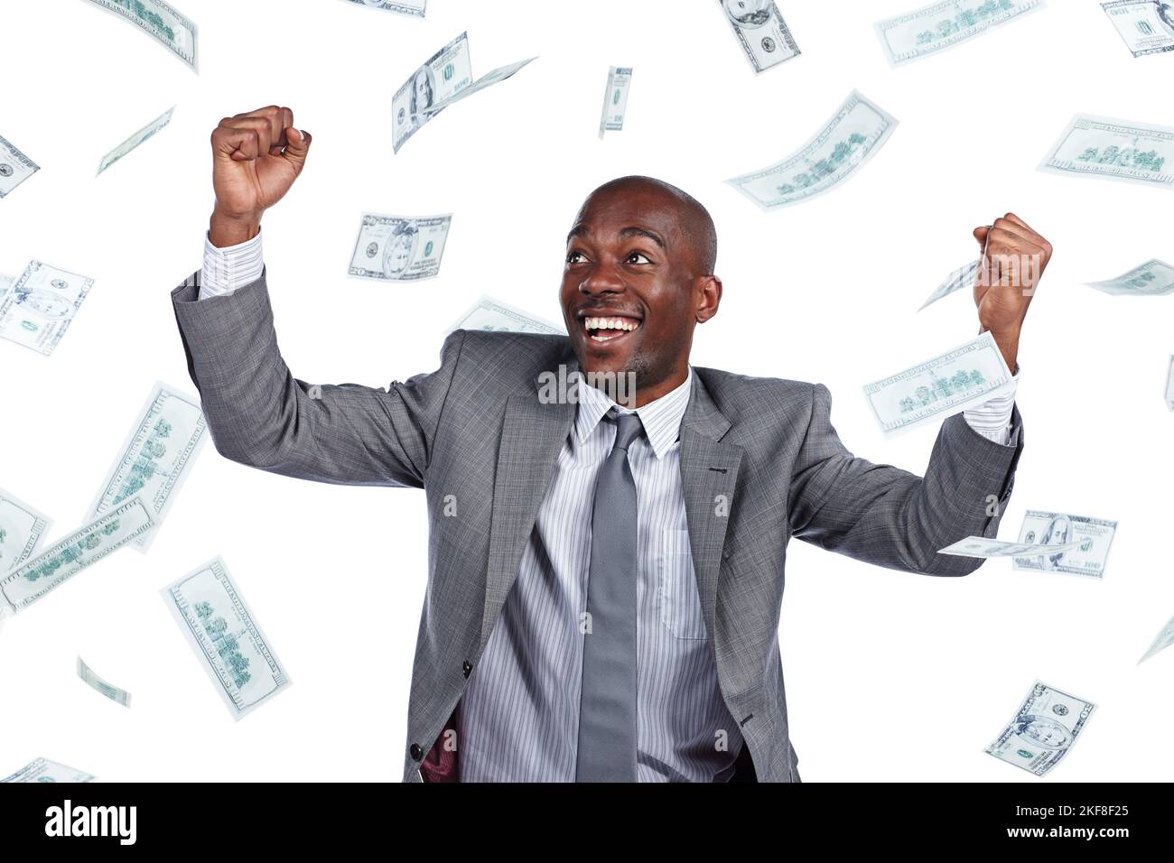 Hard work pays off. a businessman cheering as money rains down against ...