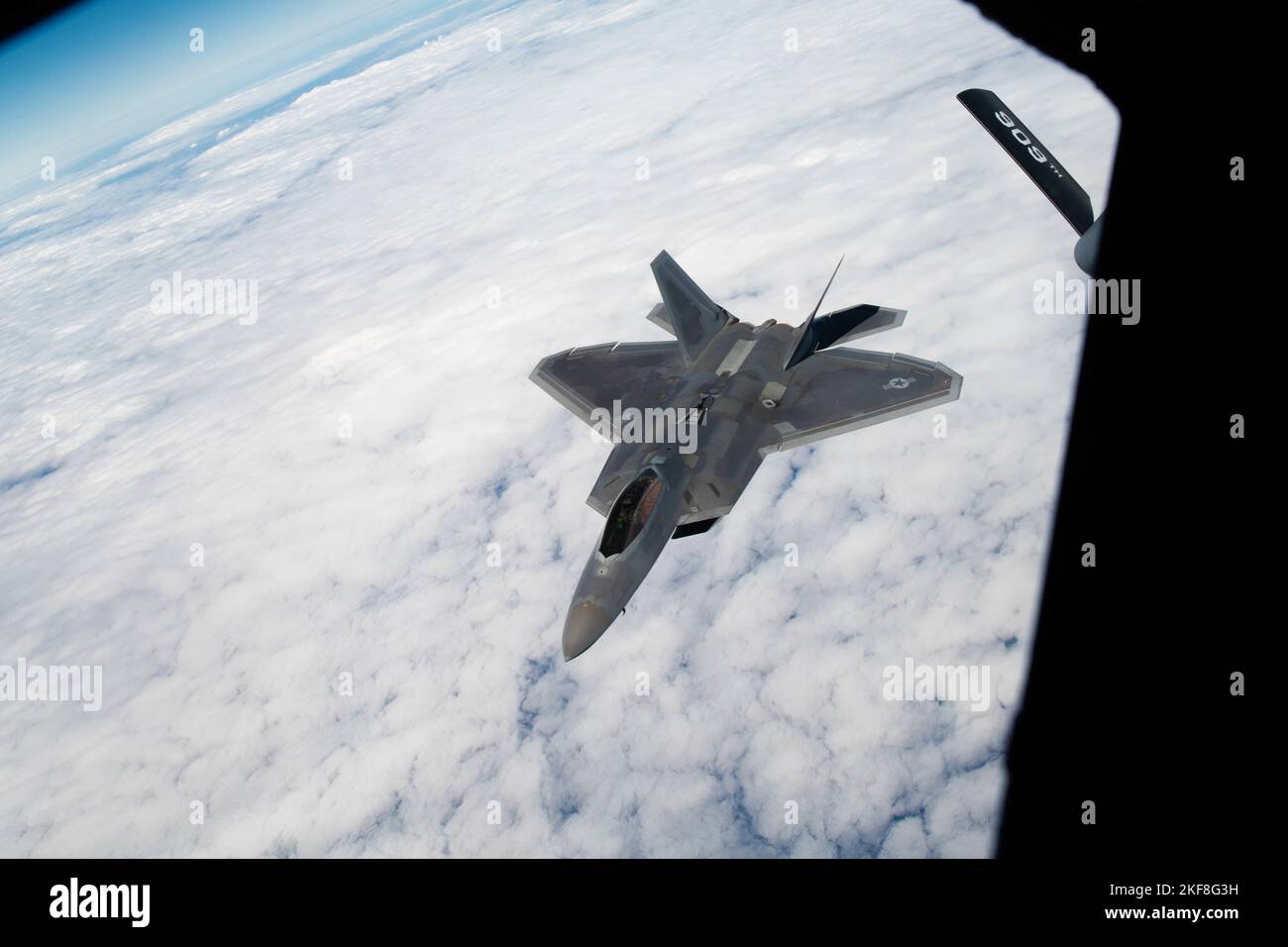 A U.S. Air Force F-22A Raptor assigned to the 3rd Wing, flies alongside ...