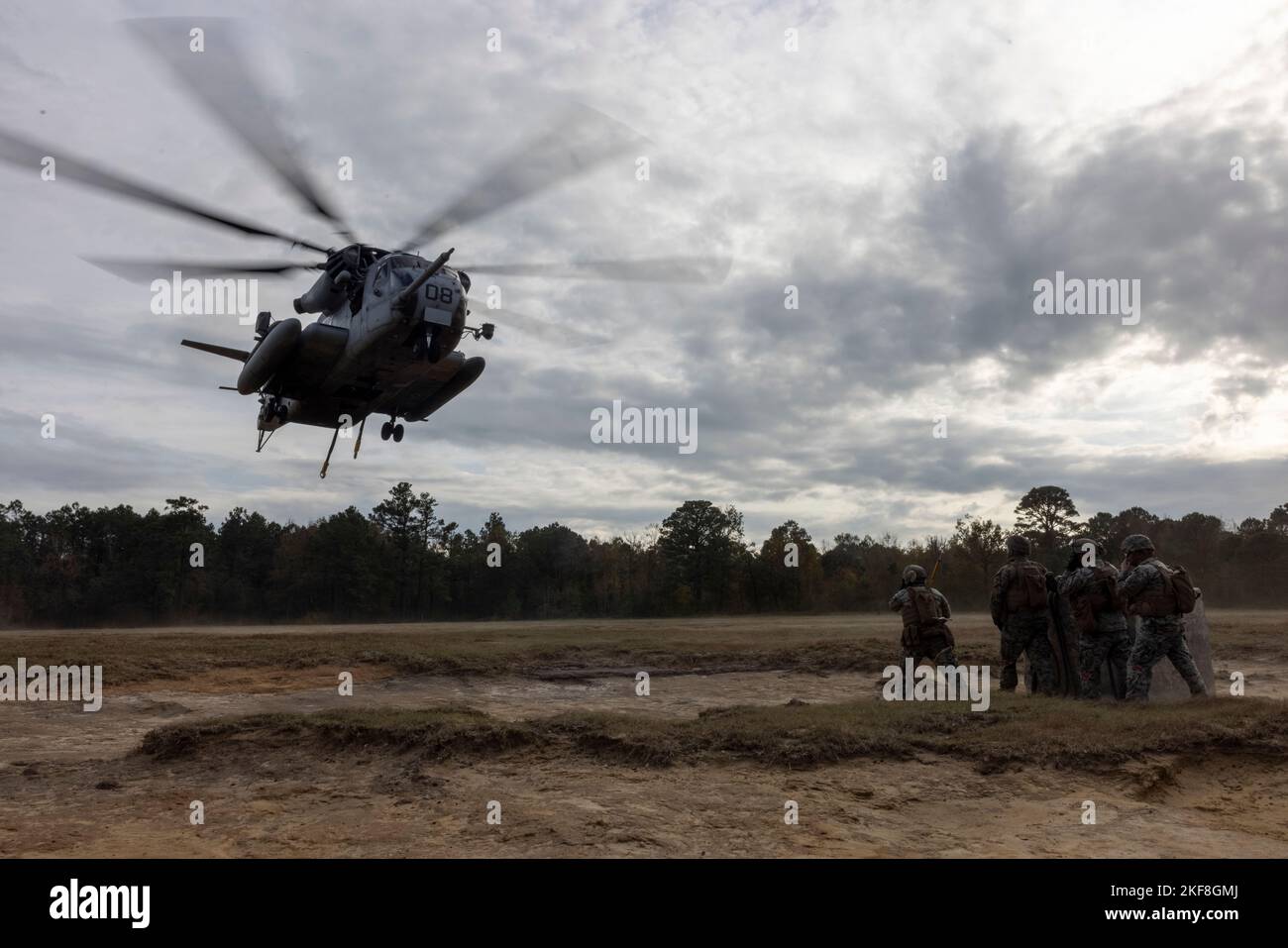 U.S. Marines with Combat Logistics Battalion (CLB) 22 wait for a CH-53E ...