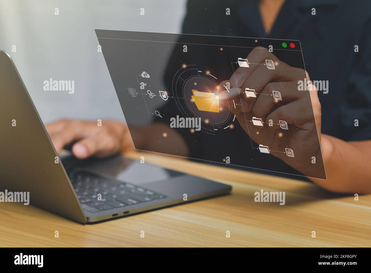 An IT consultant working on a laptop with an online documentation ...