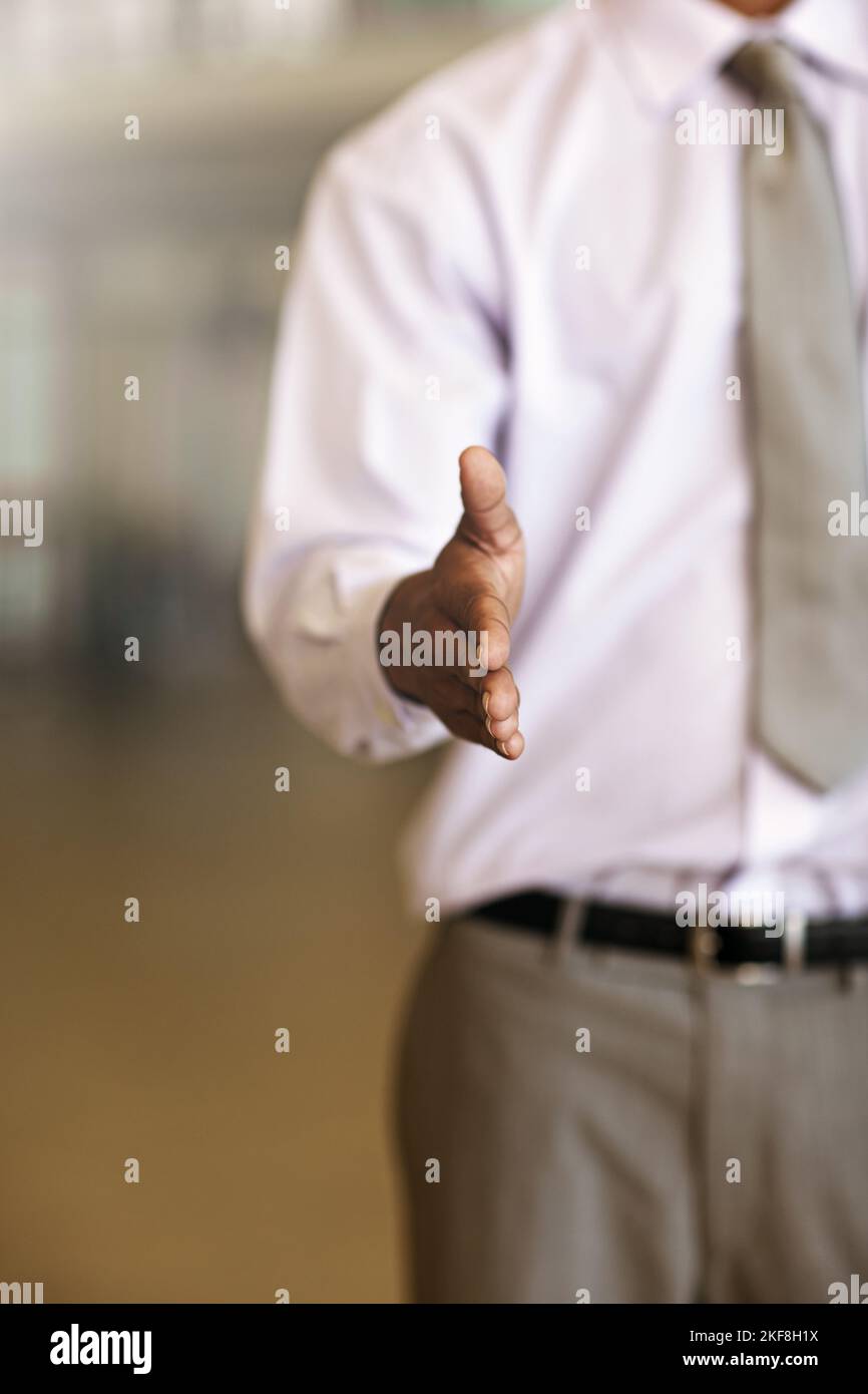 Make your move. Mid section of a business man stretching out hand for a ...