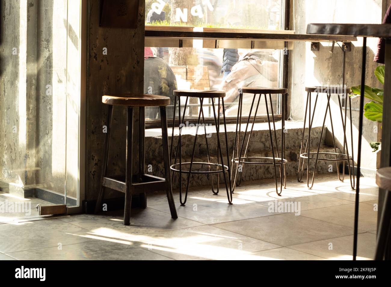 interior of a cafe with chairs in the light of the sun, a coffee shop ...