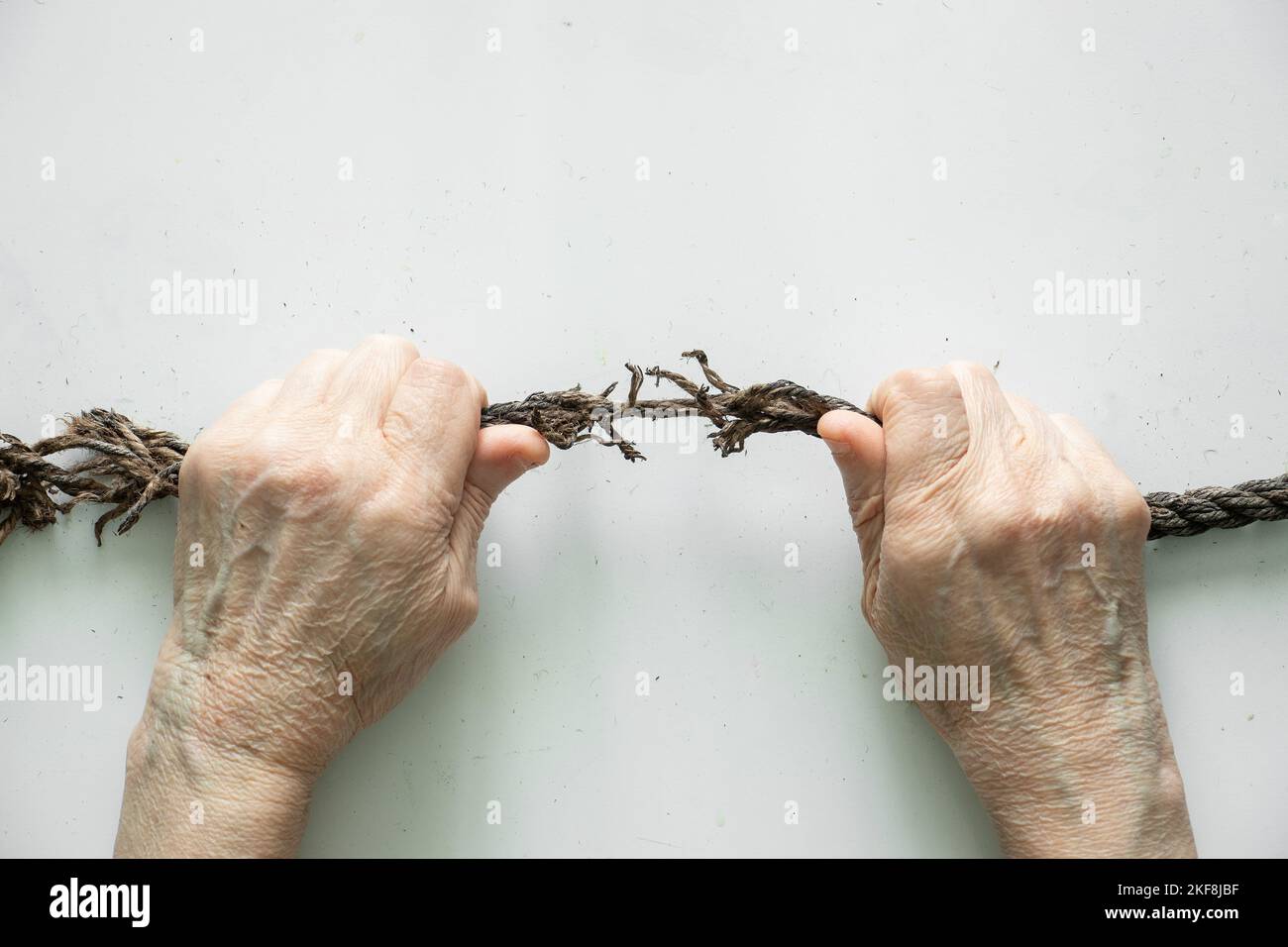 hands pull an old rope on a white background, human strength Stock ...