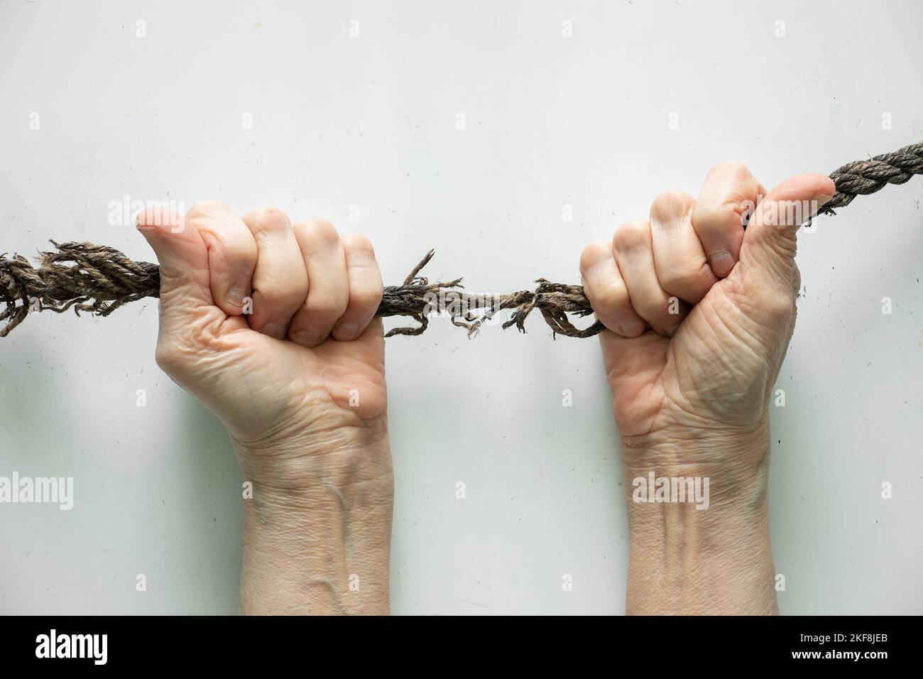hands pull an old rope on a white background, human strength Stock ...