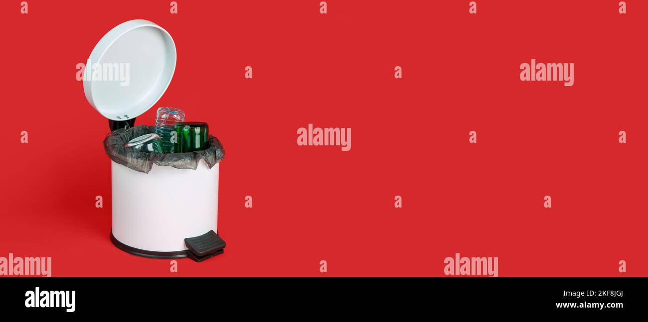 Open trash bin on red background with space for text Stock Photo - Alamy