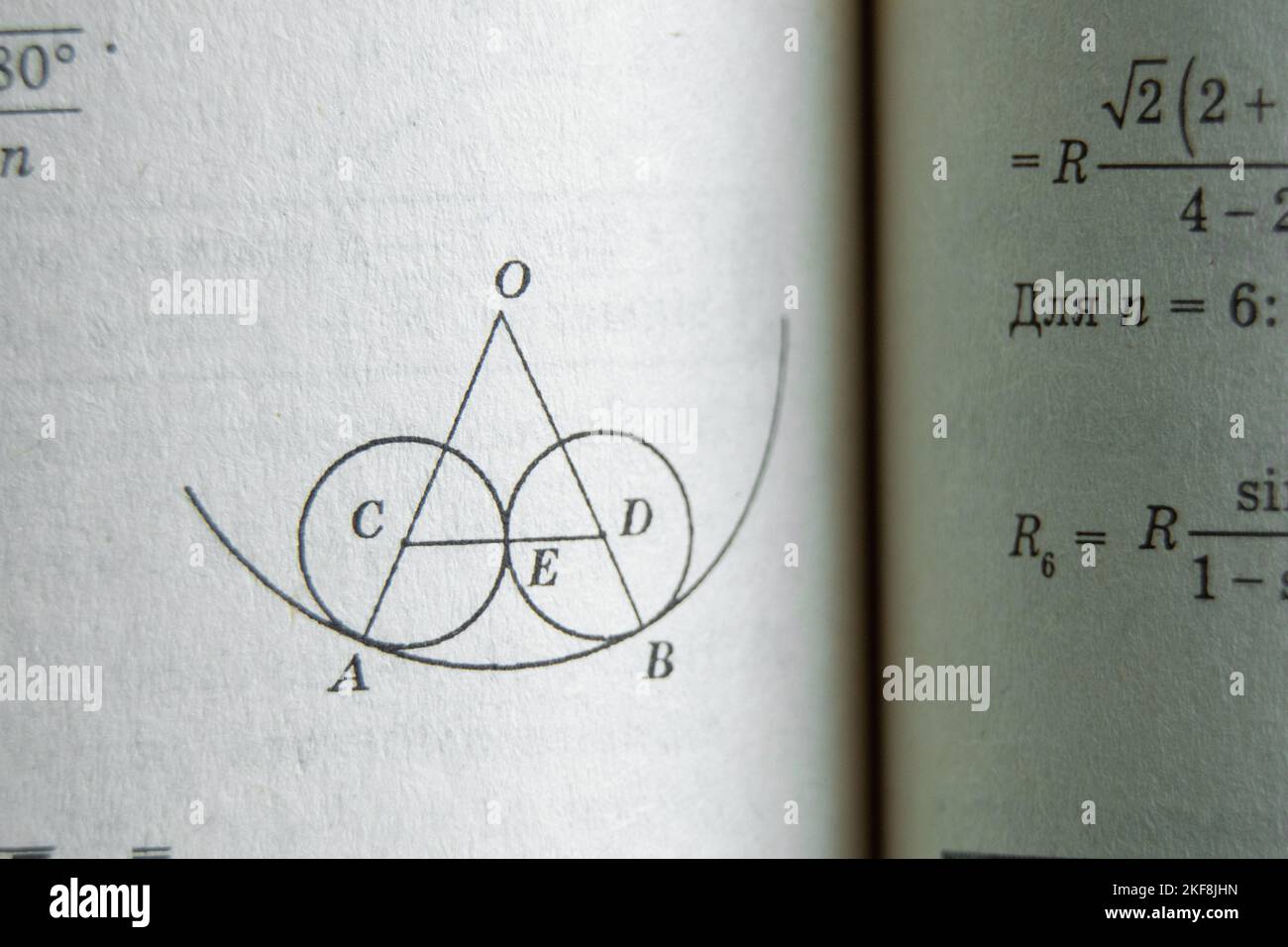 geometry drawing on page of old yellow book as background, algebra book ...
