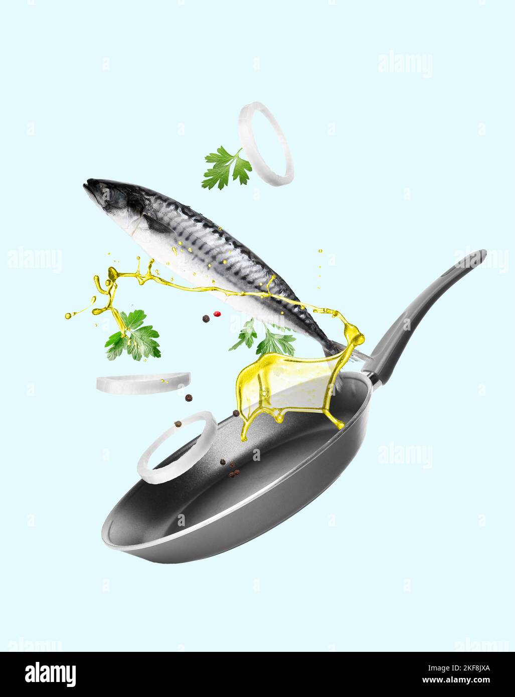 Flying fresh fish with splashes of oil, spices and frying pan on light ...