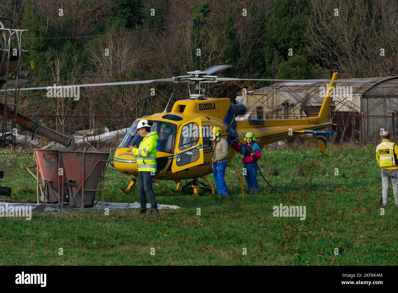A group of Construction workers loading a helicopter used for building ...