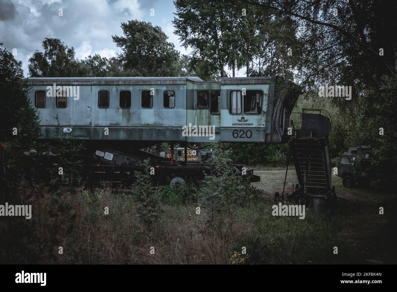 An Old jet bridge sitting in a field with trees Stock Photo - Alamy