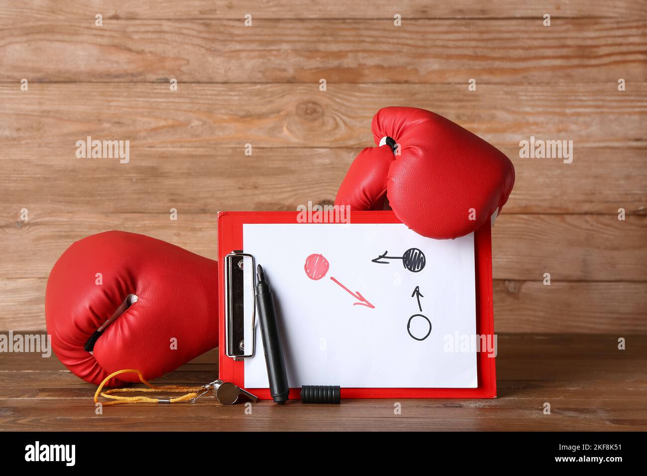 Clipboard with drawn scheme of boxing game, marker, whistle and gloves ...