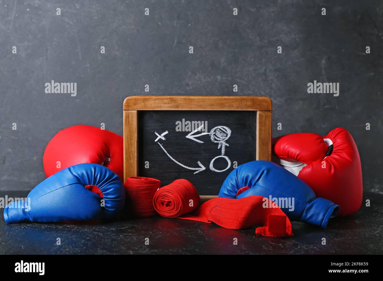 Chalkboard with drawn scheme of boxing game, gloves and bandages on ...