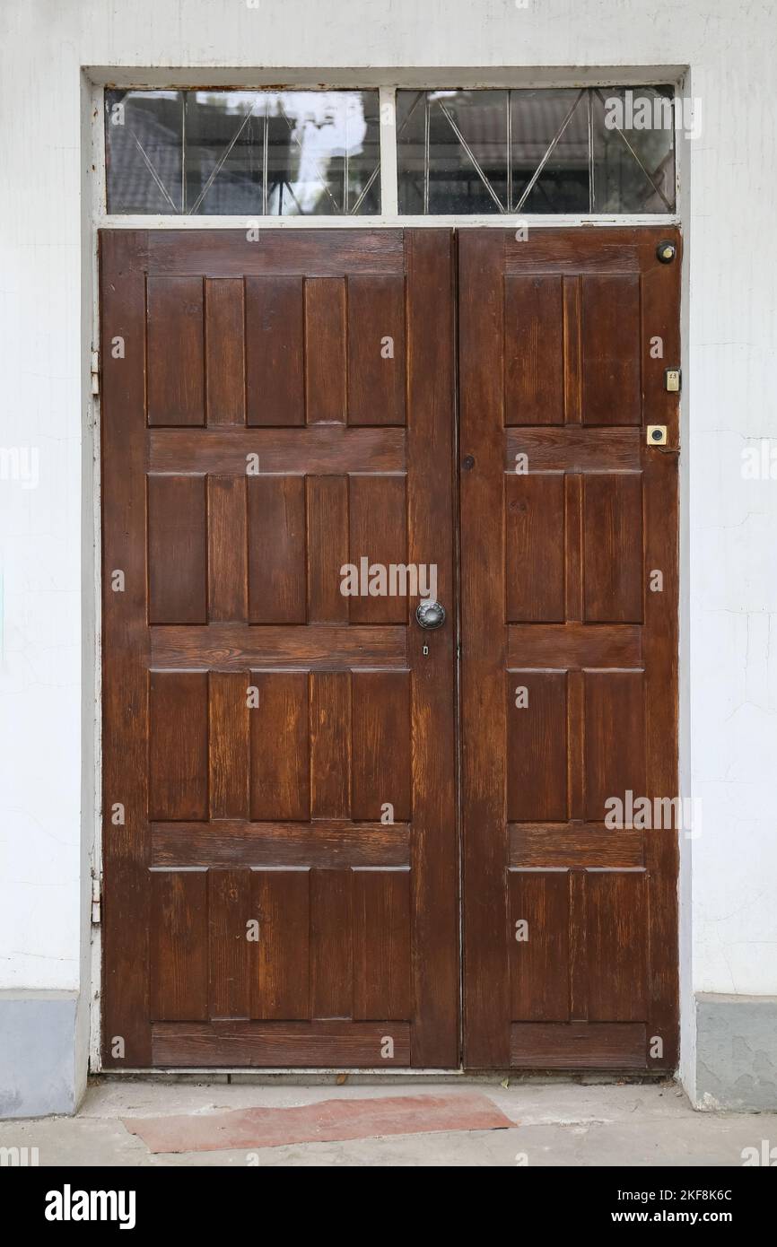 Building with wooden door and transom window Stock Photo - Alamy