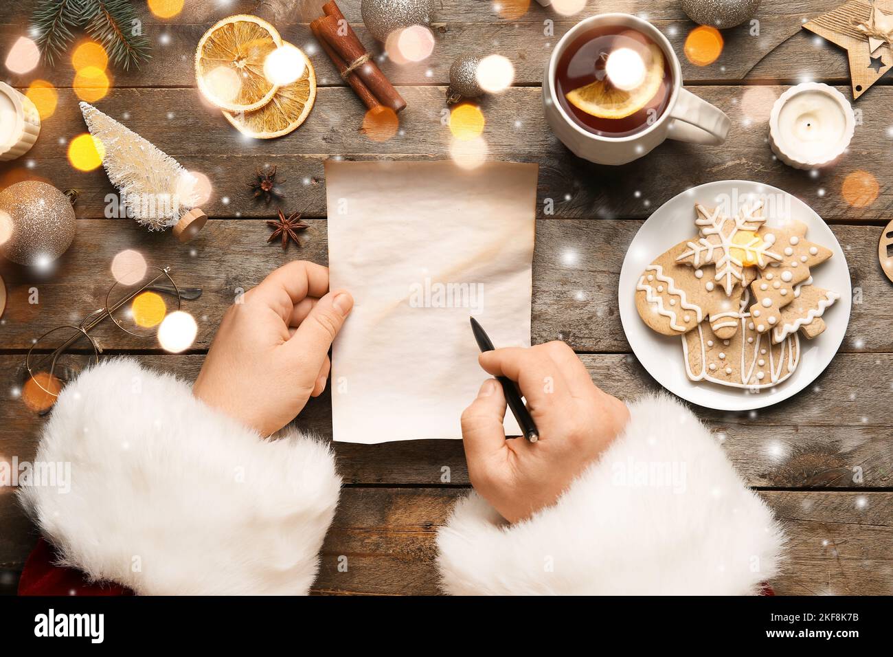 Santa Claus with blank letter, pen, Christmas cookies and tea on wooden ...