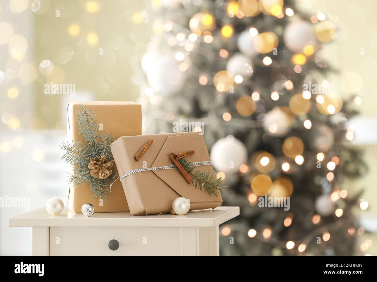 Beautiful Christmas gift boxes on table in room Stock Photo - Alamy