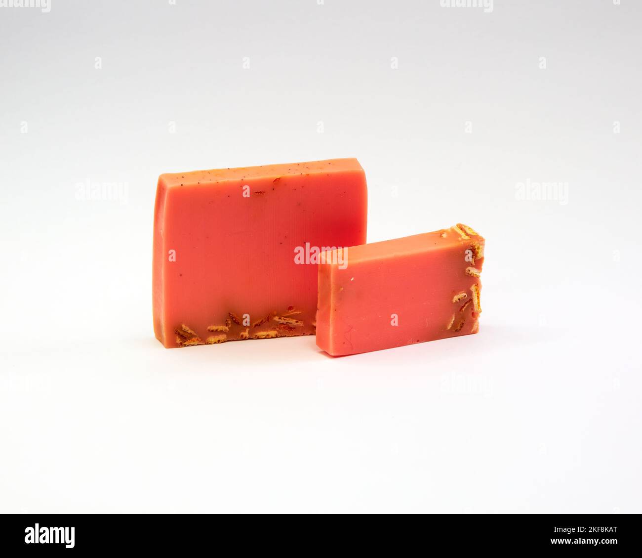 A closeup of orange-scented soap bars isolated on a white background ...