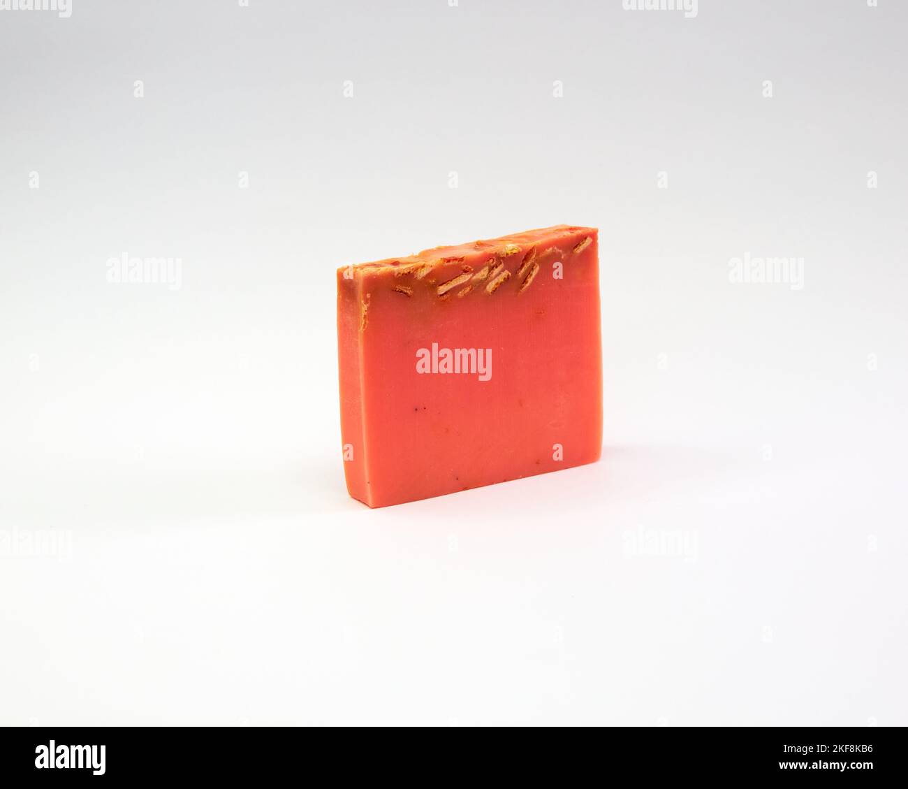 A closeup of an orange-scented soap bar isolated on a white background ...