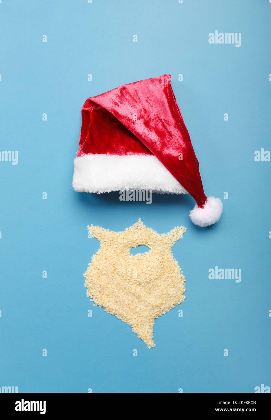 Santa hat with beard made of grains on blue background Stock Photo - Alamy