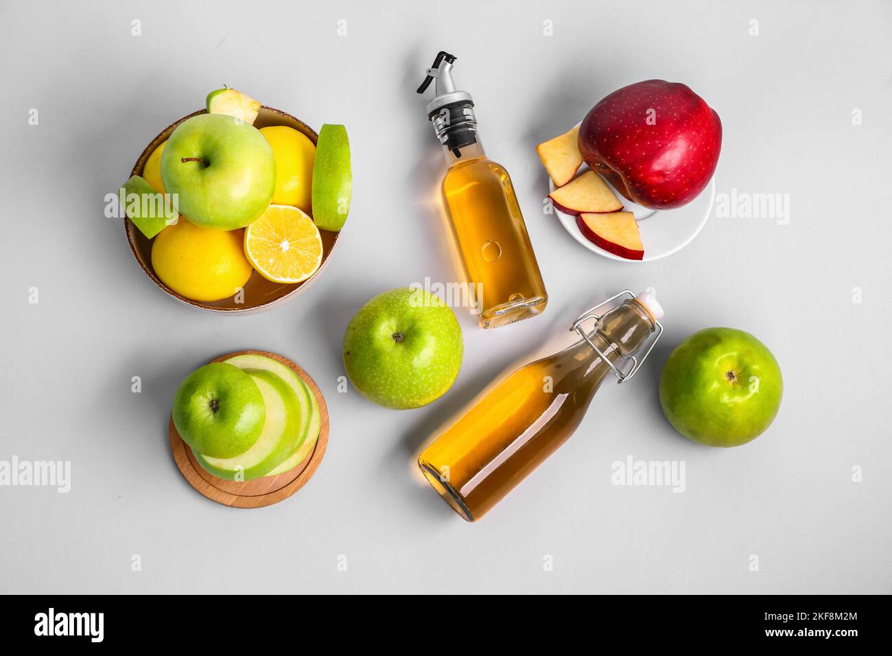 Composition with bottles of apple cider vinegar and fresh fruits on ...