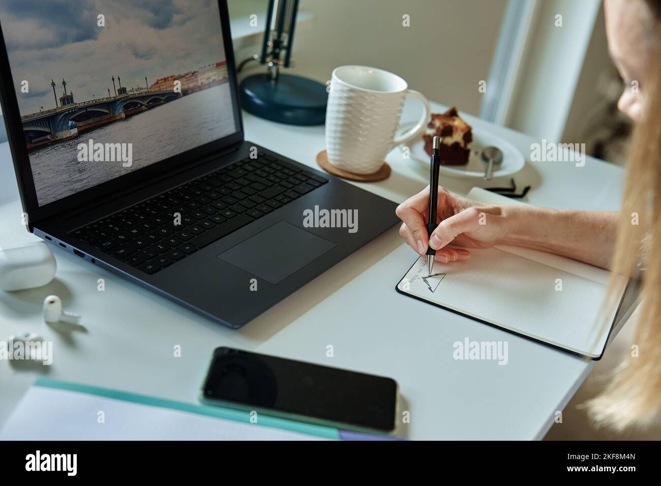 Home office workplace with laptop. Woman working remotely from home ...