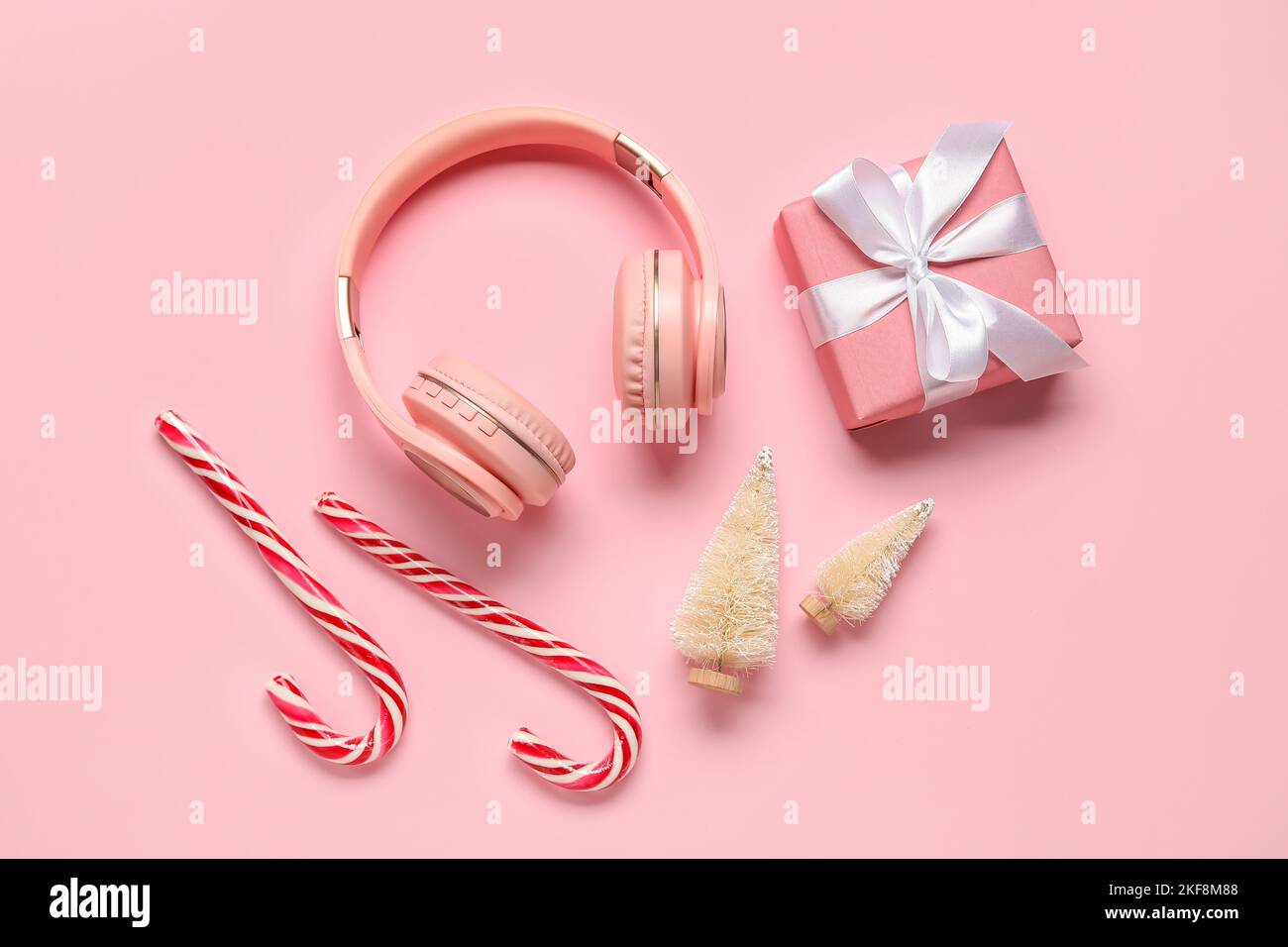 Composition with modern headphones, candy canes, Christmas gift and ...
