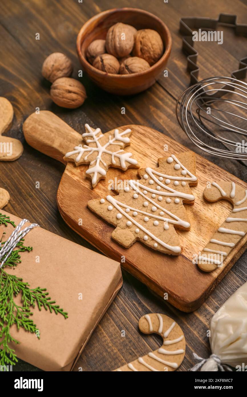 Board with tasty Christmas cookies on wooden background, closeup Stock ...