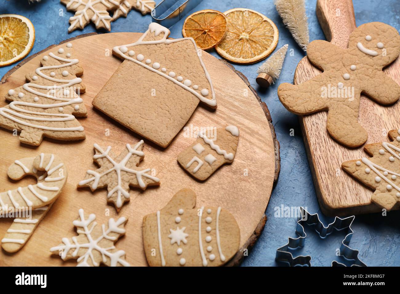 Wooden board with sweet Christmas cookies on color background, closeup ...