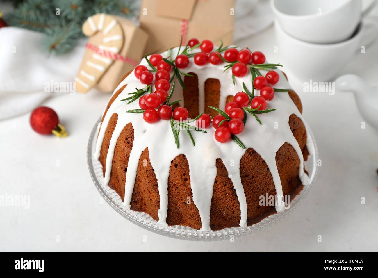 Dessert stand with traditional Christmas cake on light table Stock ...