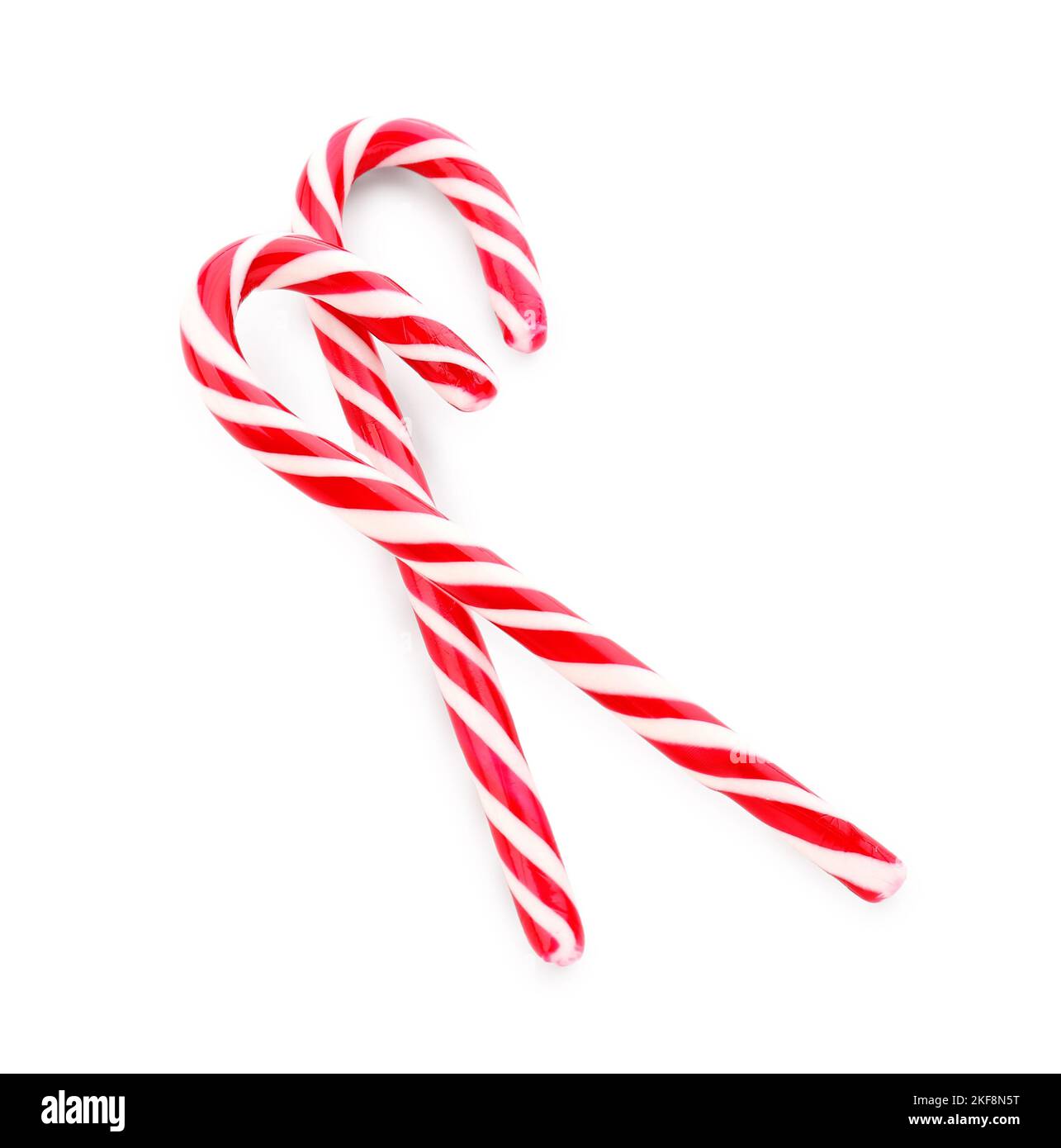 Delicious candy canes on white background Stock Photo - Alamy