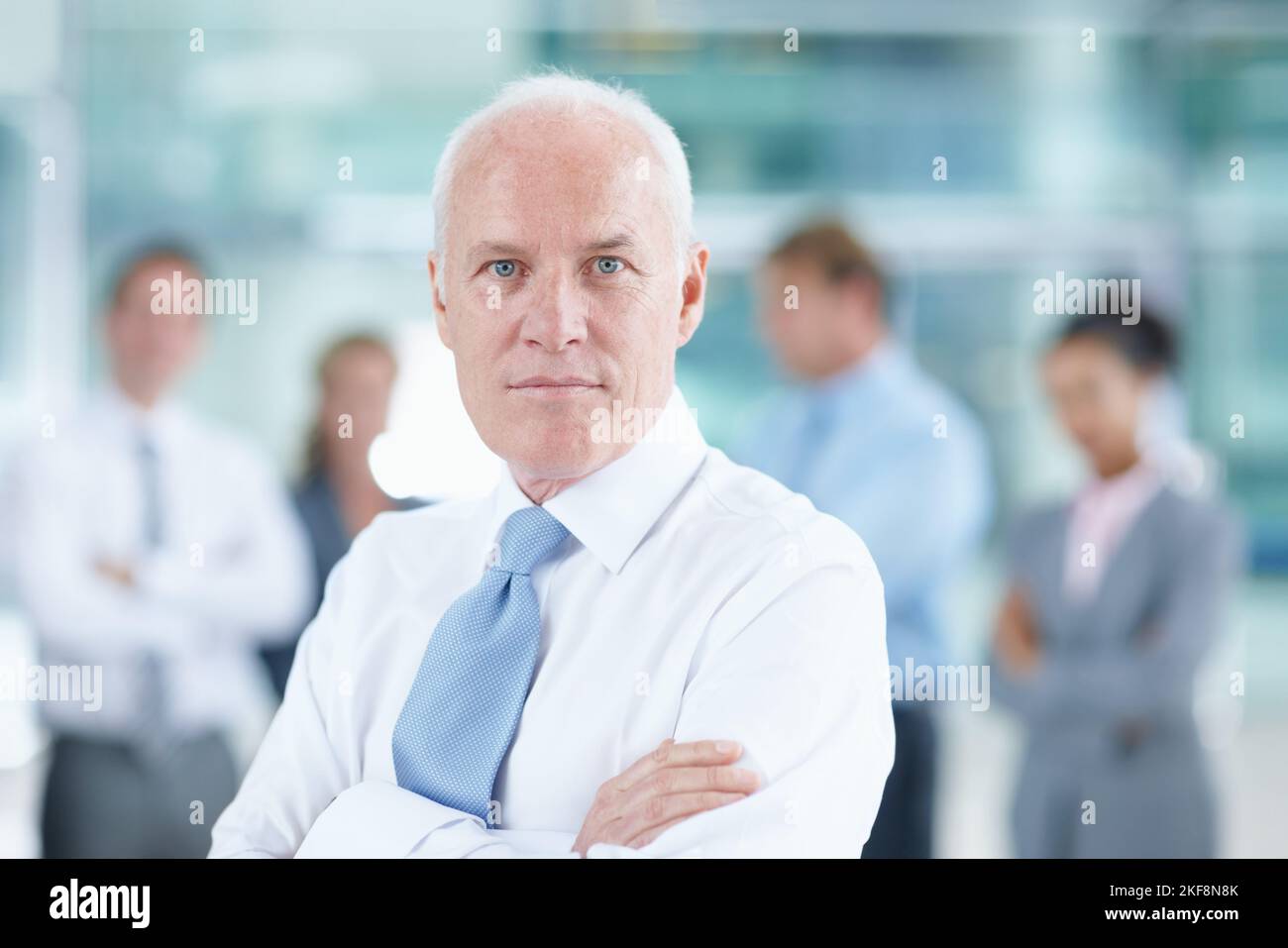 Focused on corporate excellence. Senior businessman standing with his ...