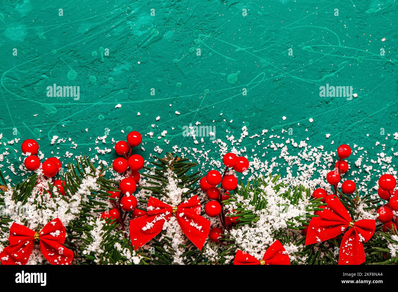 Composition with fir branches, red berries, bows and snow on color ...