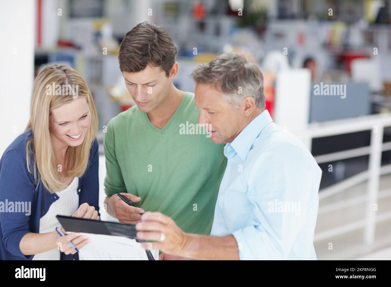 Teamwork makes the load lighter. Three work colleagues discussing ...