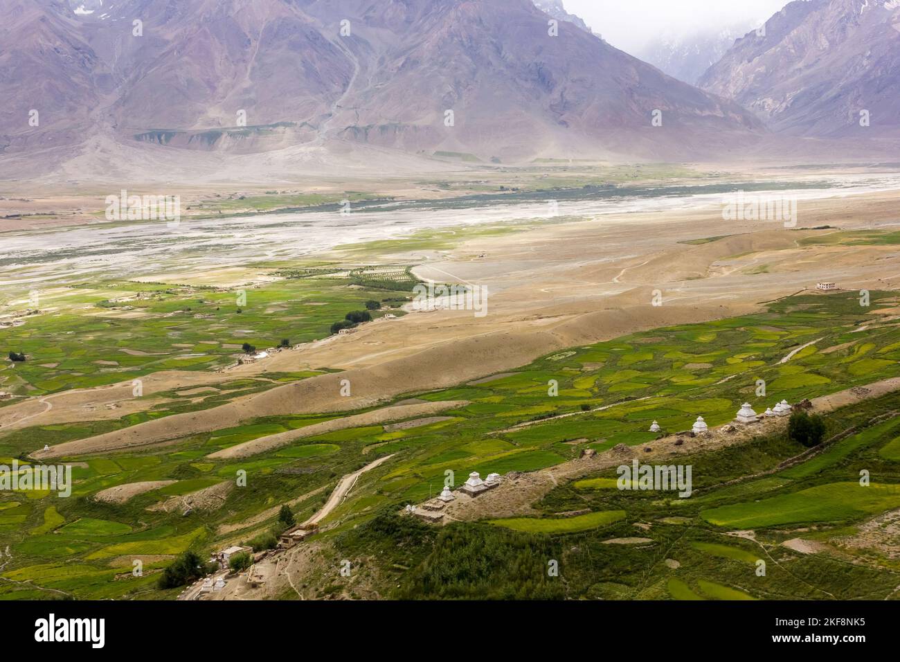 Aerial view of green fields in an epic landscape of a village in the ...