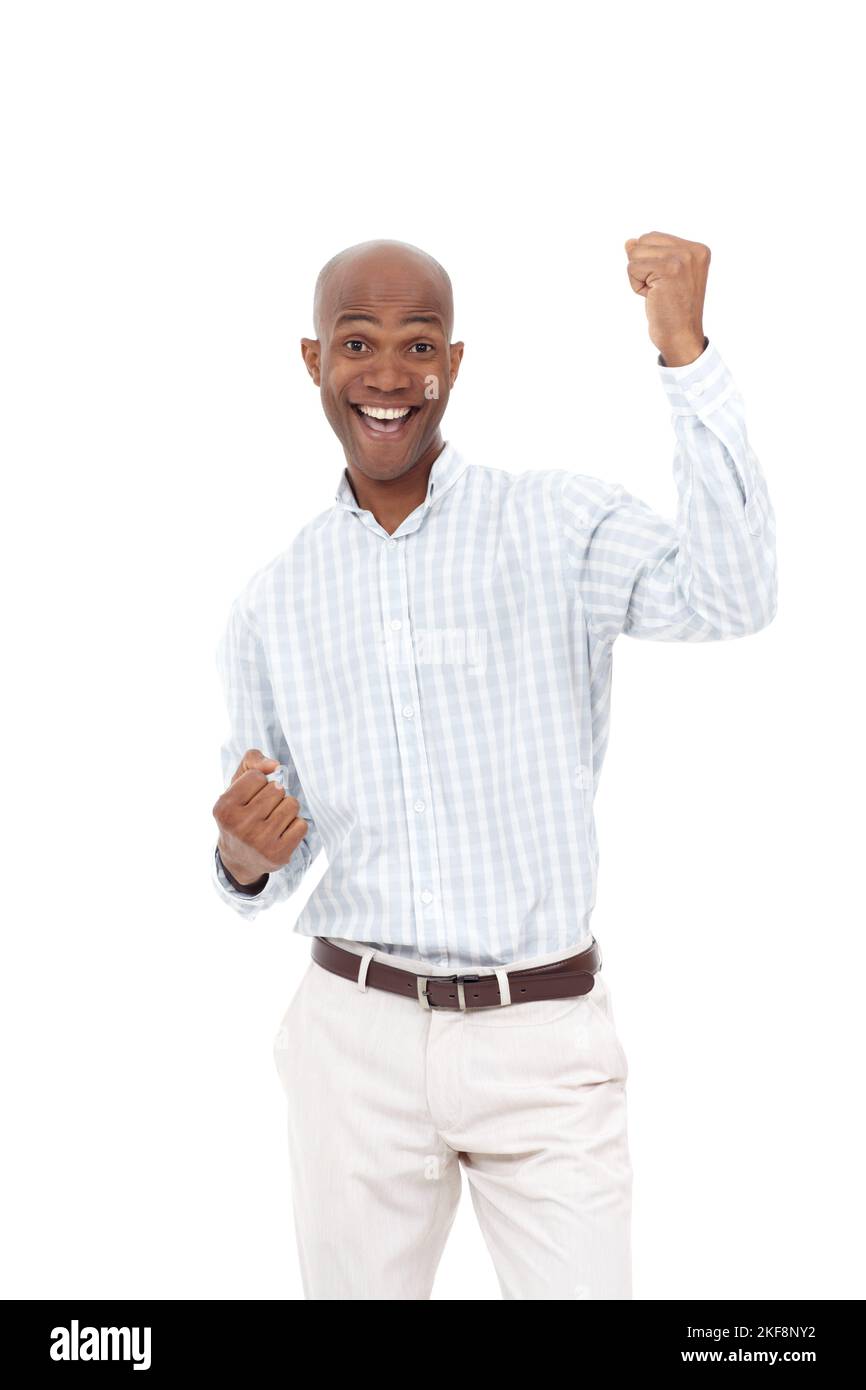 OHHH yeah. Studio portrait of an excited young man raising his arms up in the air in celebration ...