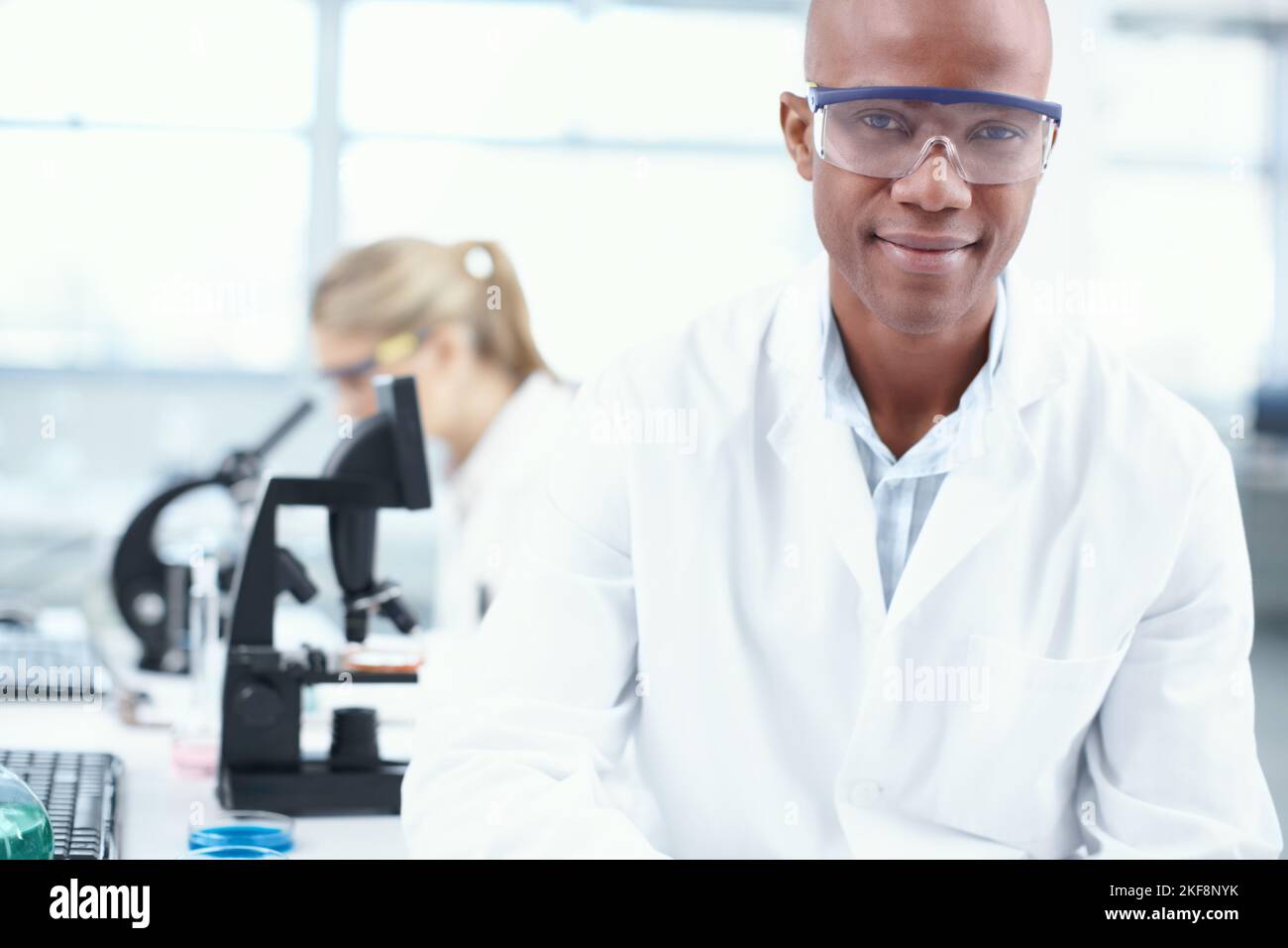 The science guy. Portrait of a smiling young chemist in the lab with a ...
