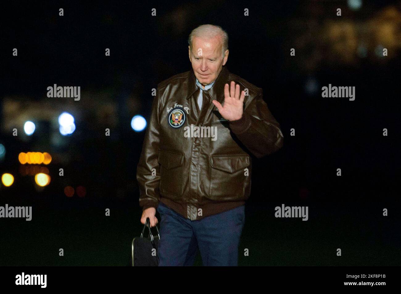 President Joe Biden waves to reporters after departing Marine One on ...