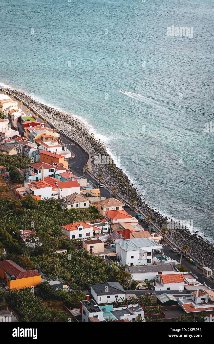 An aerial view of the sea against houses on the beach on a sunny day ...