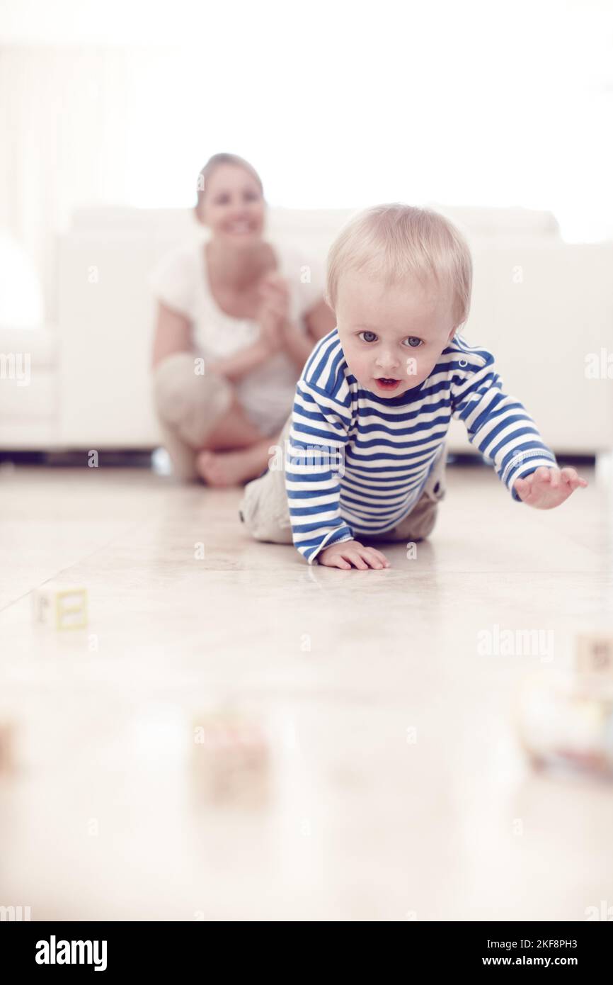 Look, hes crawling. A cute baby boy crawling on the floor as his proud ...