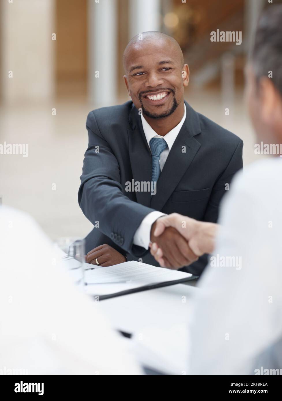 I look forward to working with you. Two business executives reaching an ...