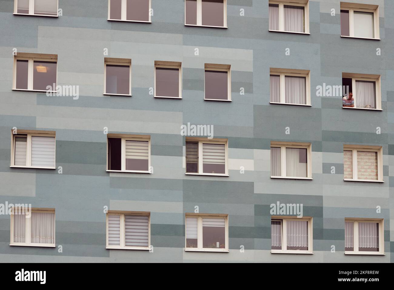 A closeup of a modern gray apartment building with square windows at ...