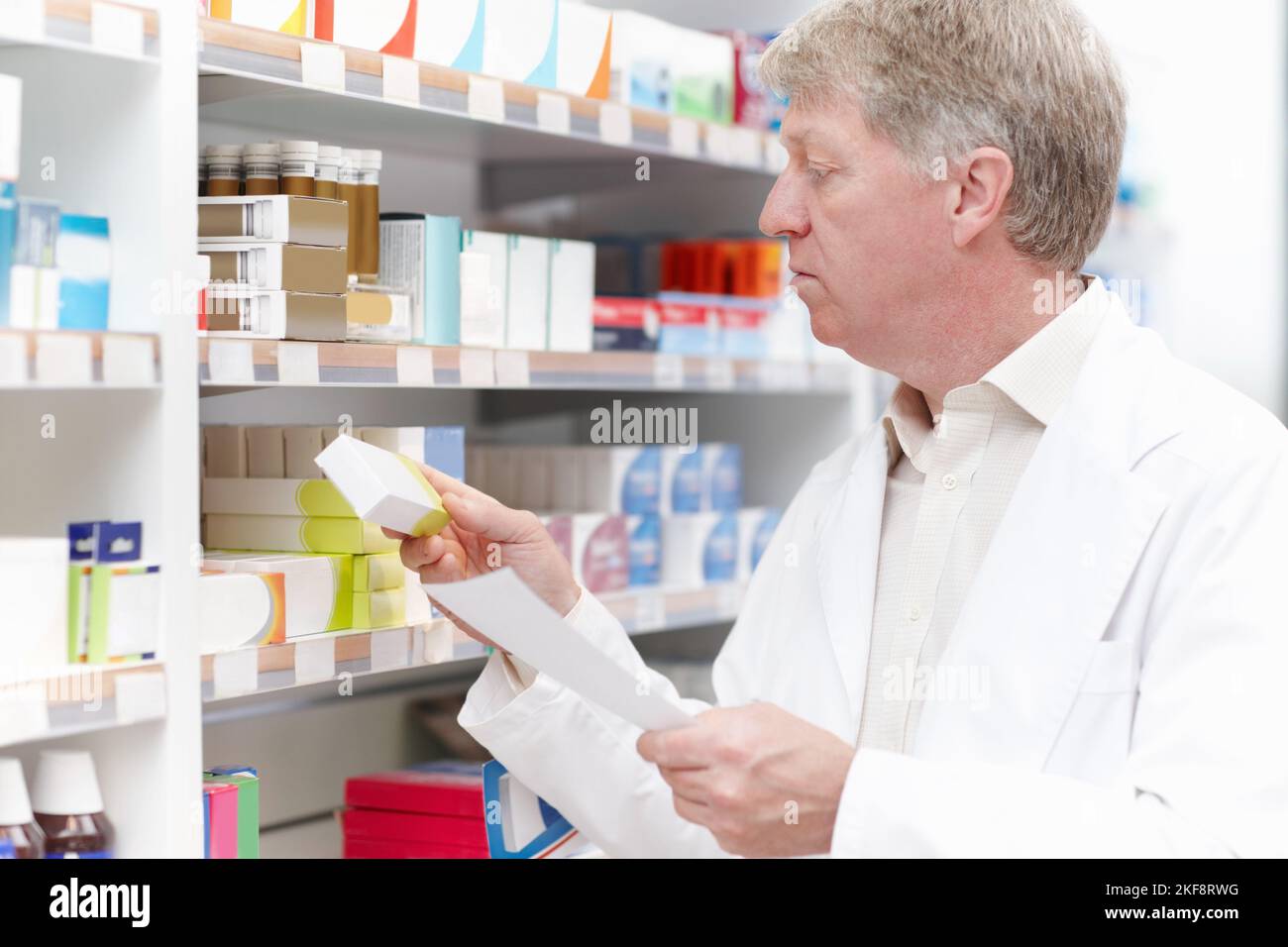 Pharmacist examining the medicine. Portrait of handsome pharmacist ...
