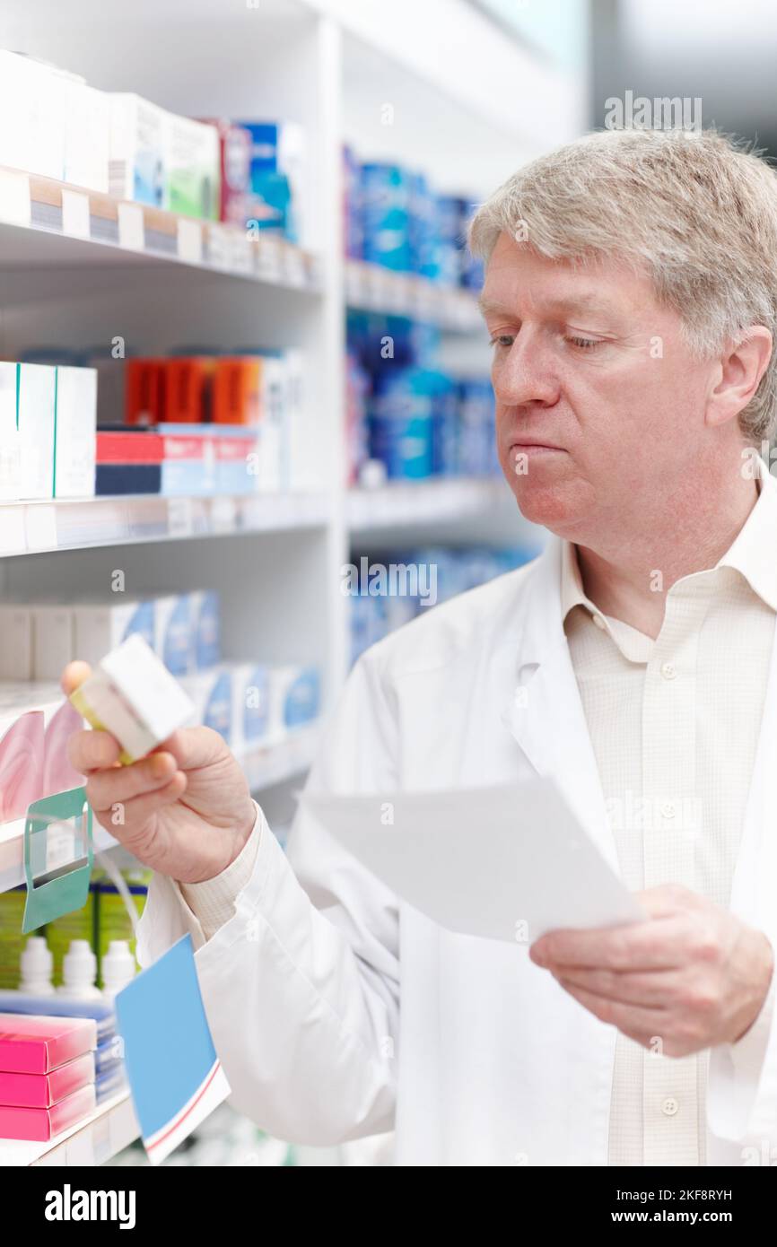 Pharmacist checking medicine with prescription. Portrait of pharmacist ...