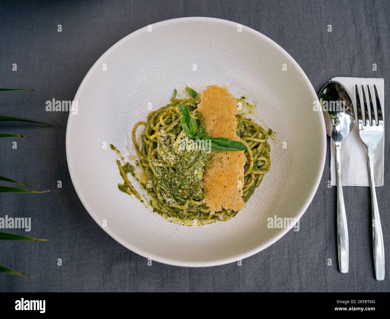 Spaghetti with pesto and coconut under palm tree Stock Photo - Alamy