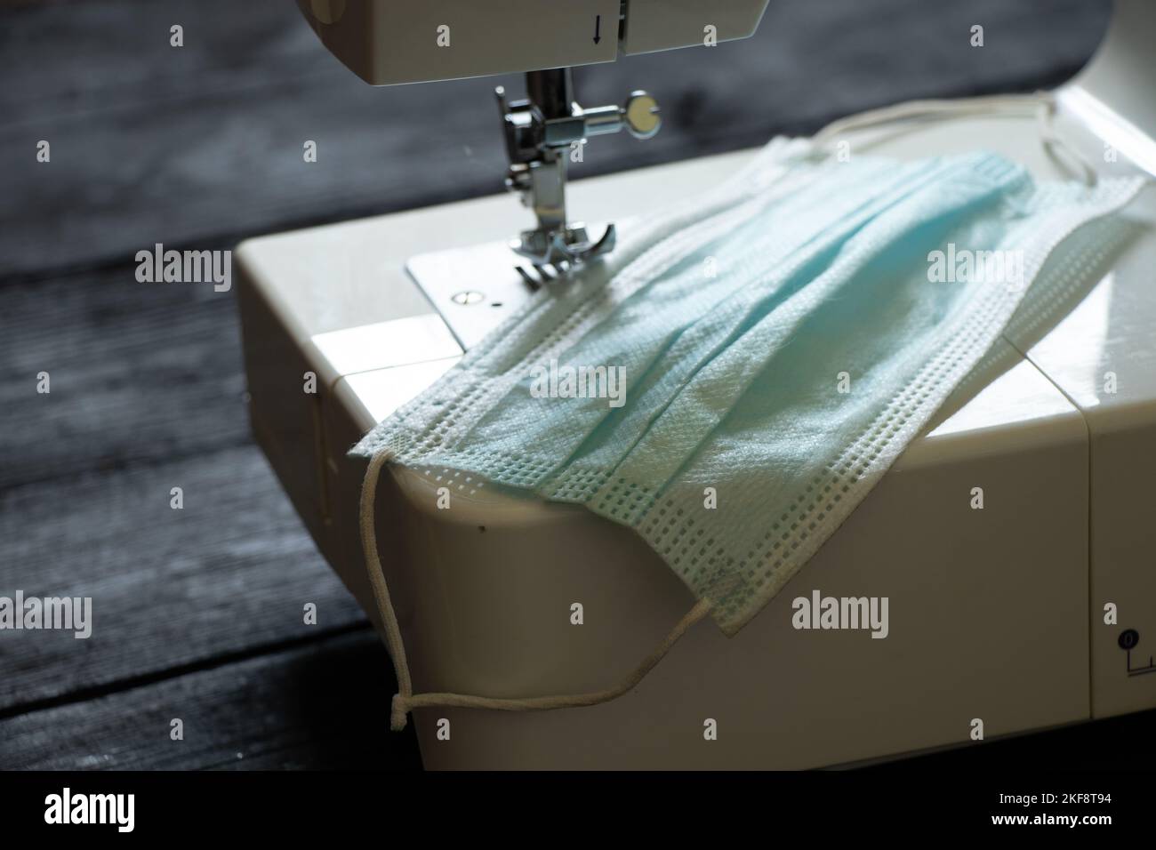 medical mask on a sewing machine on the table at home, medical mask ...