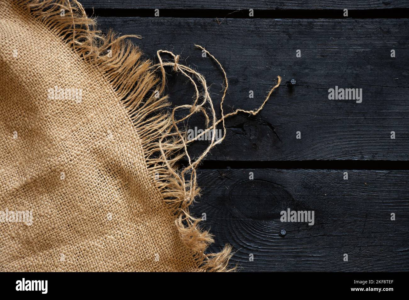 black wood board and brown fabric as background, rag on the floor, wood ...