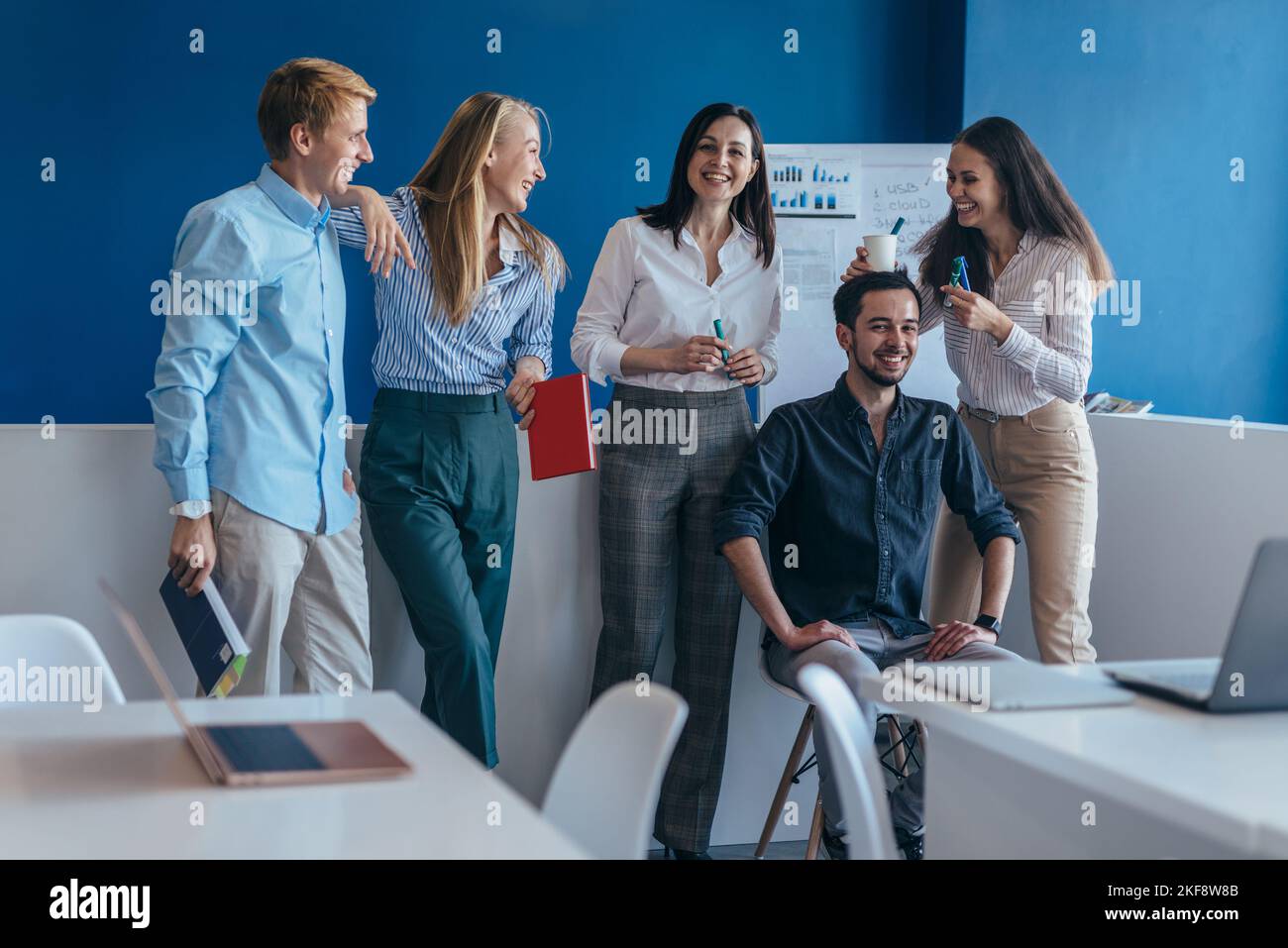 Group of young people having fun in a classroom Stock Photo - Alamy