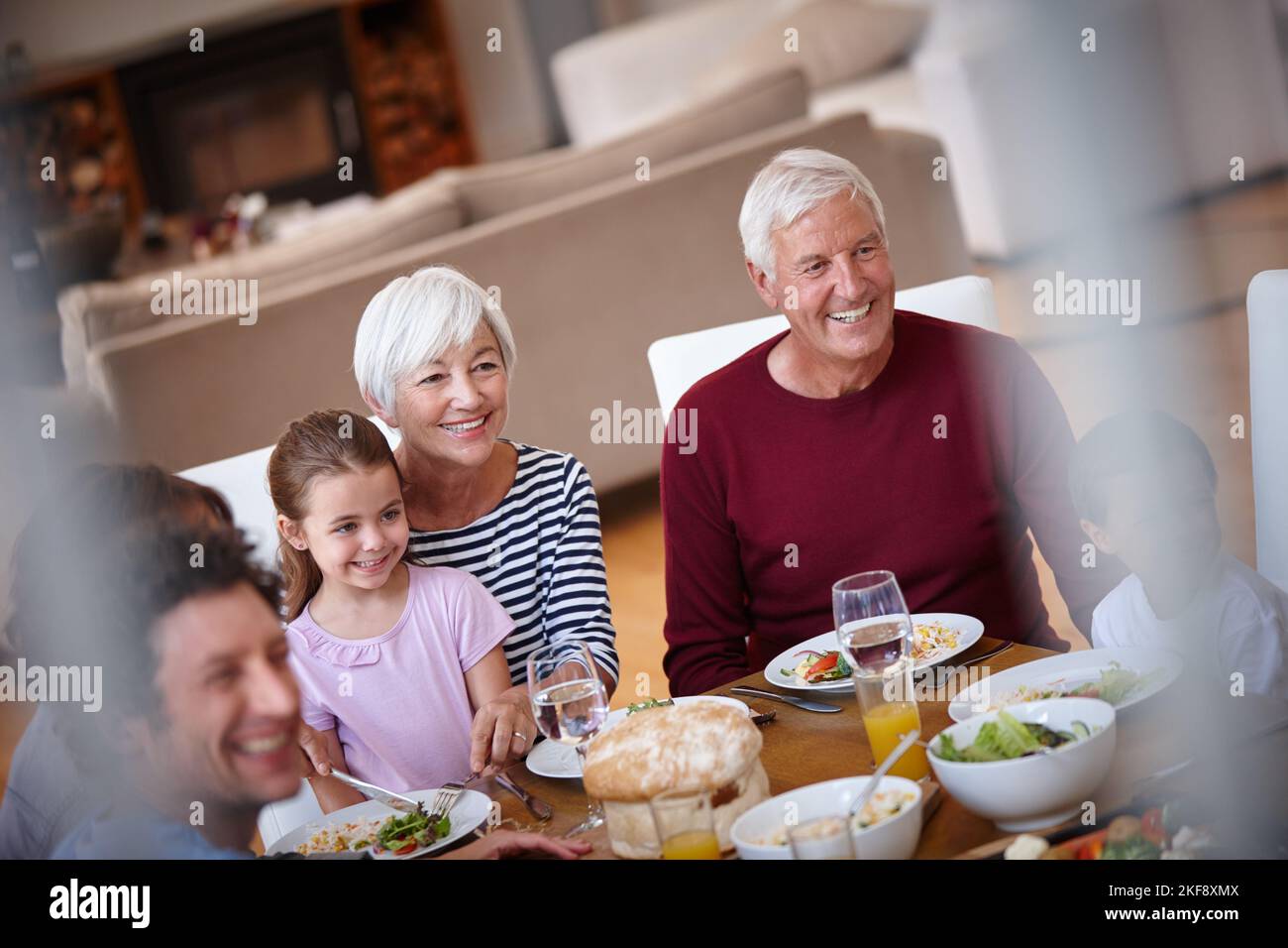 Its always fun with family. a multi generational family having a meal ...
