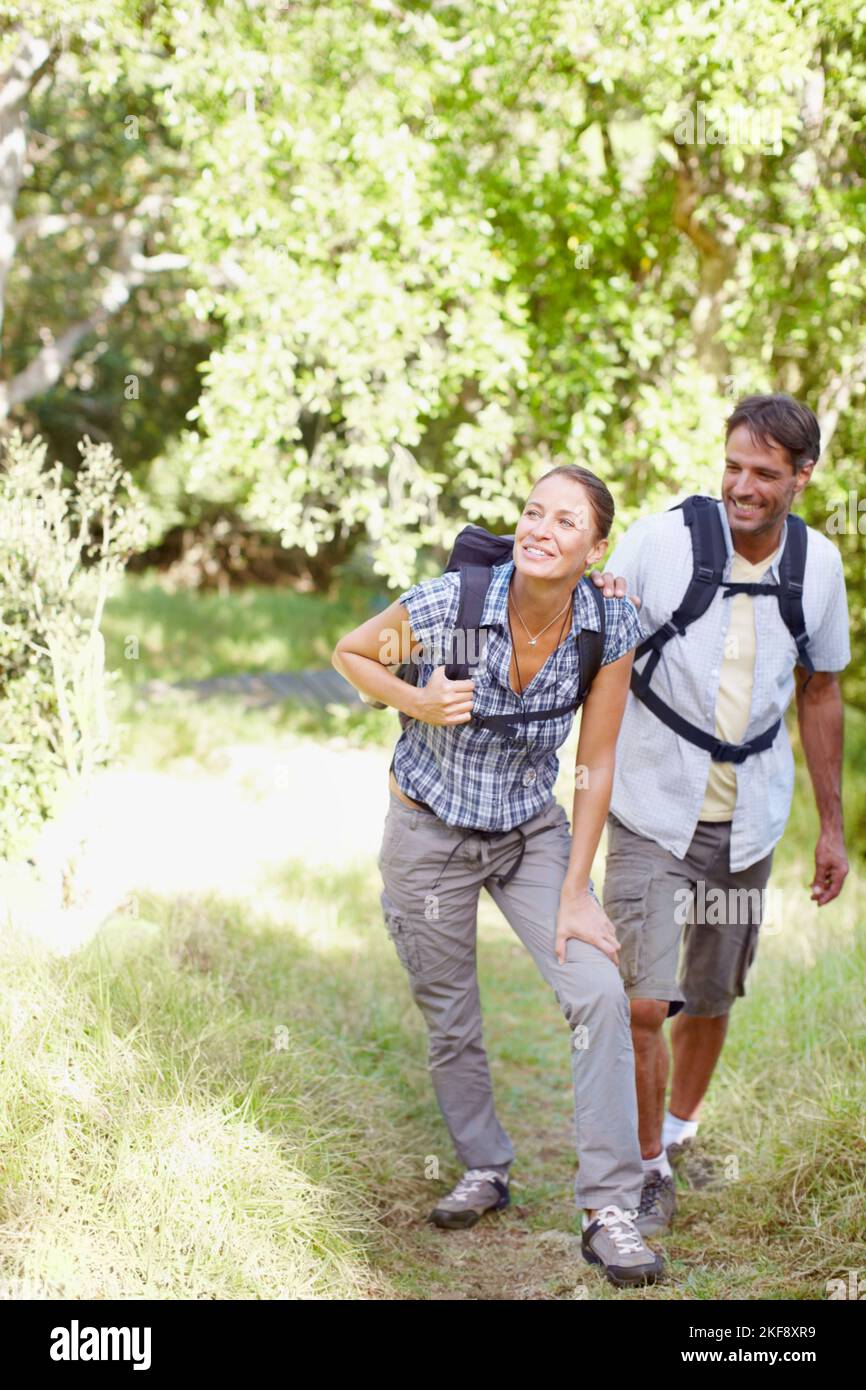 Feeling the burn in her legs after a long walk. A young couple trying ...