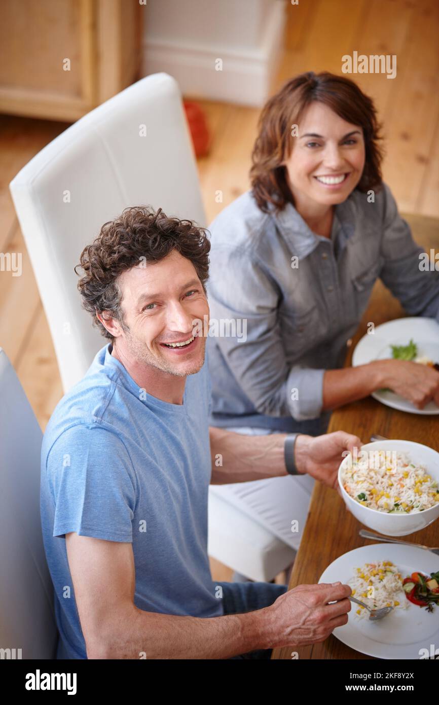Meals are always better with the one you love. Portrait of a smiling ...