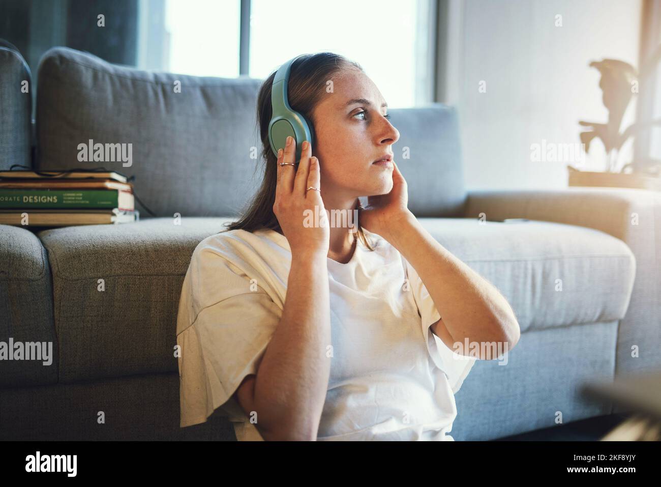 Woman relax, music headphones and peace on living room sofa, sound and ...